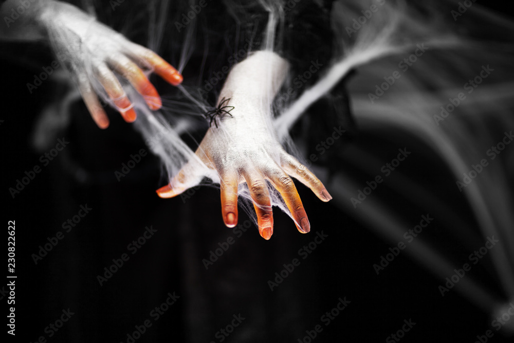 Creepy halloween hands with red, orange and silver covered in a spider ...