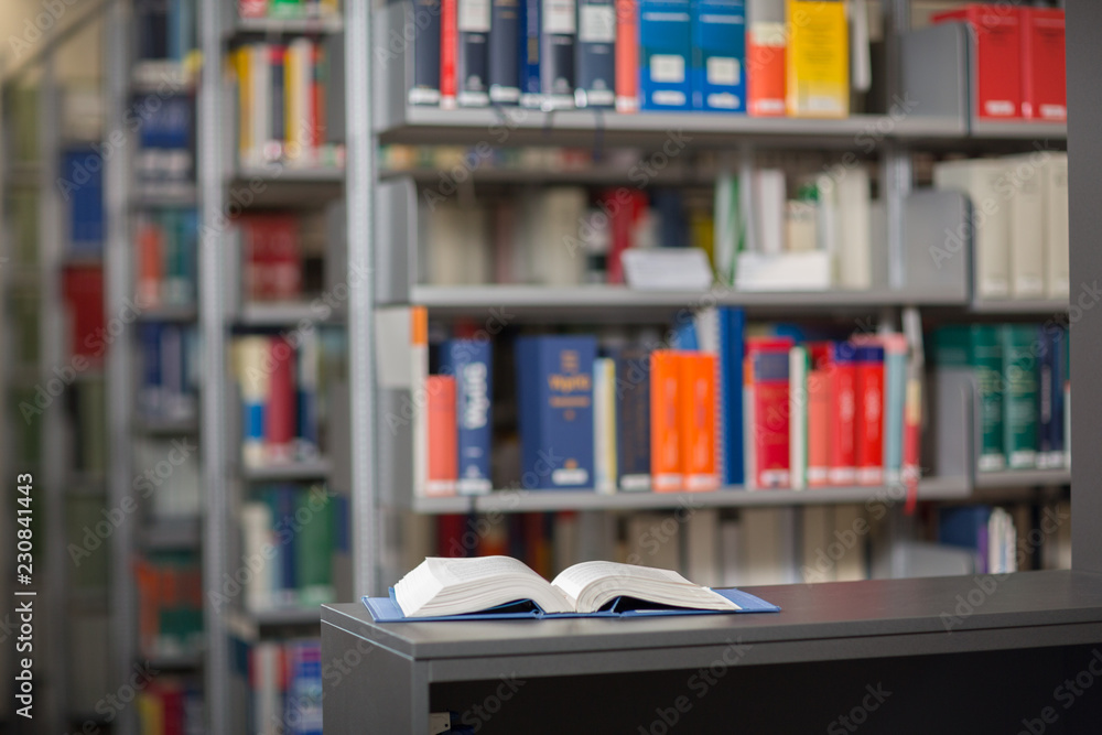 Open book in a a library Stock Photo | Adobe Stock