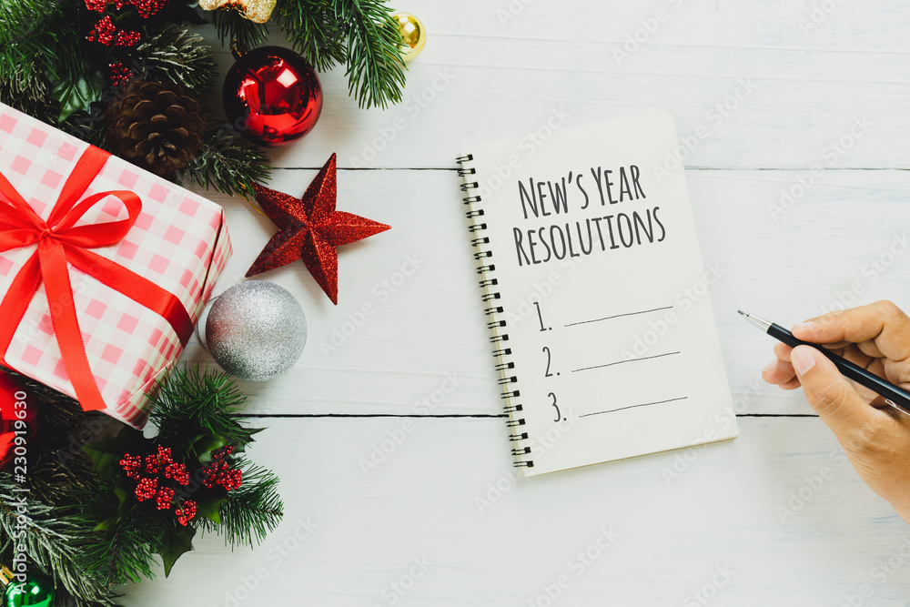 Top view of new's year resolutions on notebook and Christmas & New Year ...