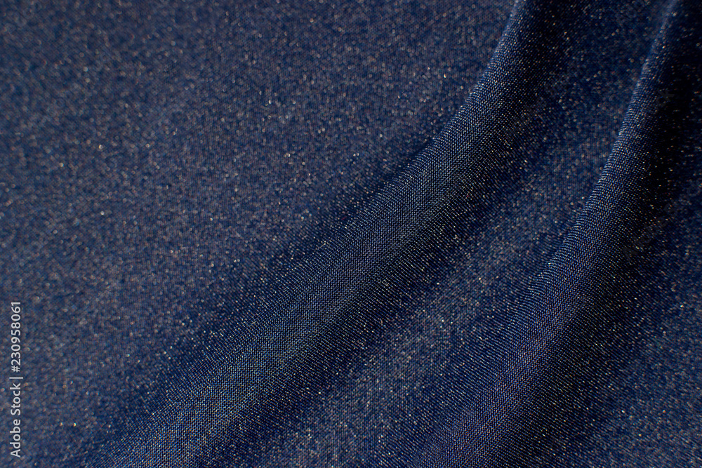 The texture of the blue fabric with folds. Macro. The texture of the ...