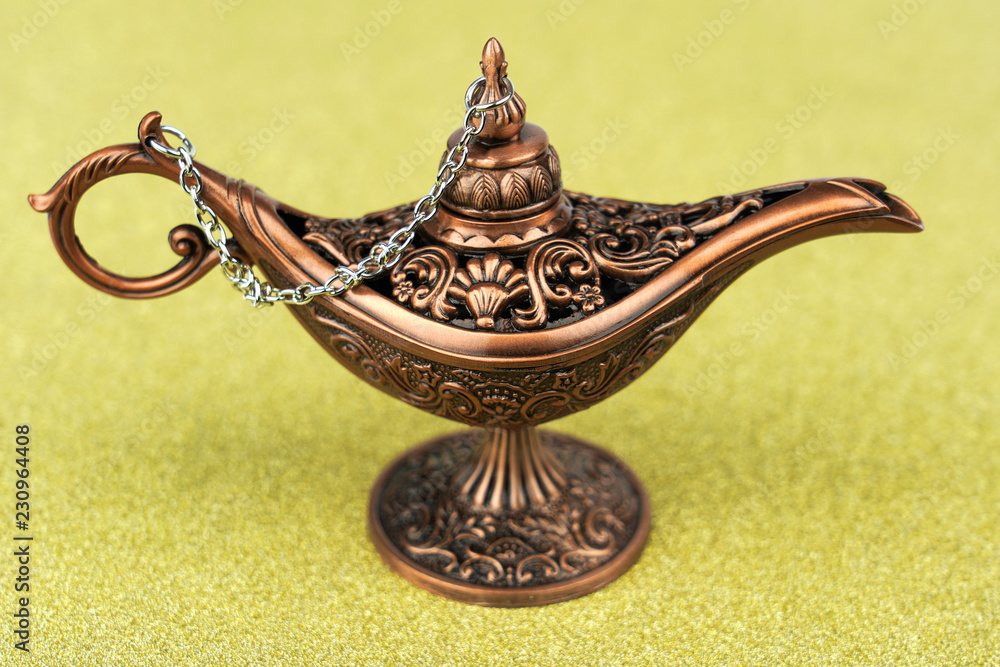 Old style arabian copper oil lamp on gold background. Stock Photo ...