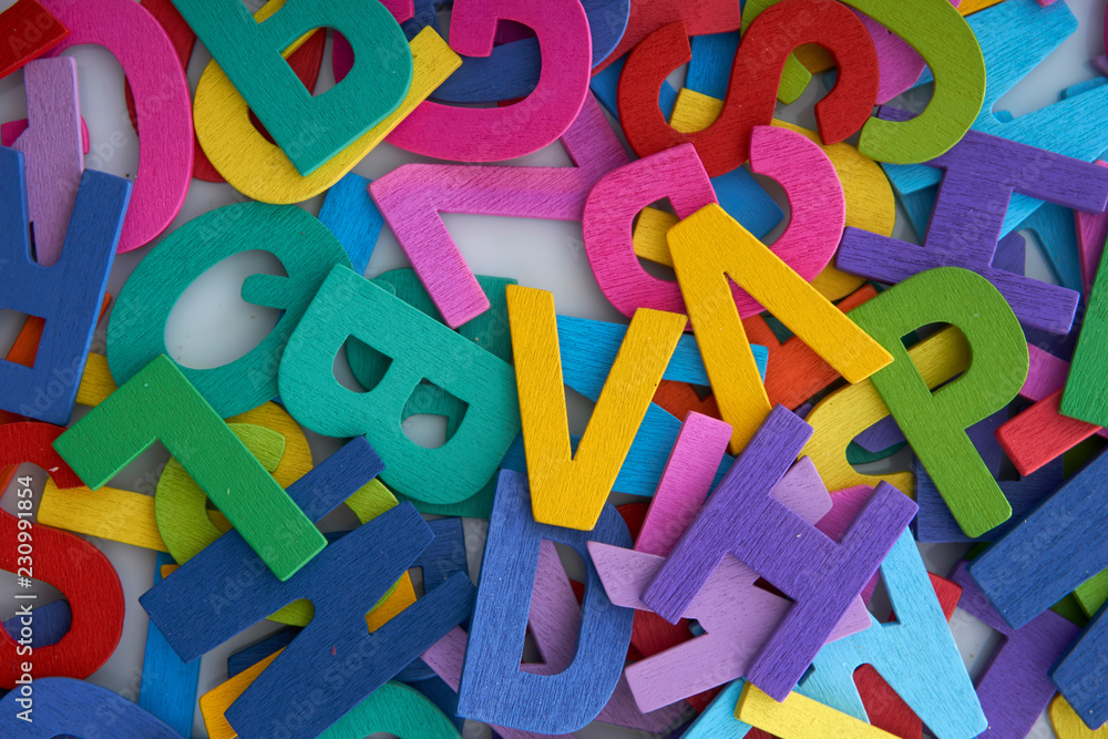 Pile of colorful wooden letters isolated over the white background with ...