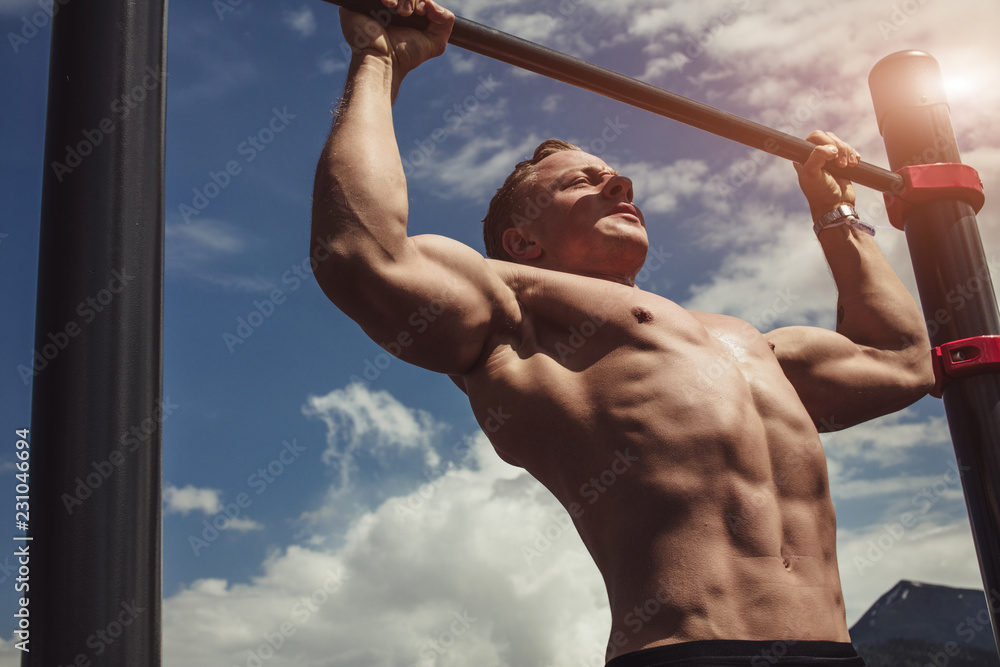 Powerful caucasian bodybuilder with perfect naked upper body with six ...