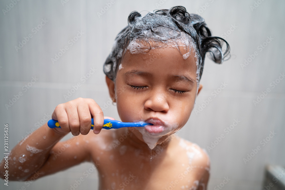 toddler brush her own teeth while taking a shower Stock Photo | Adobe Stock