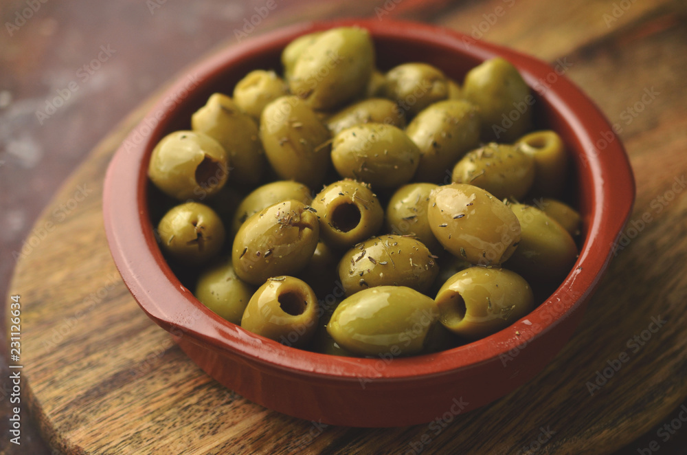 Green olives in clay bowl Stock Photo | Adobe Stock