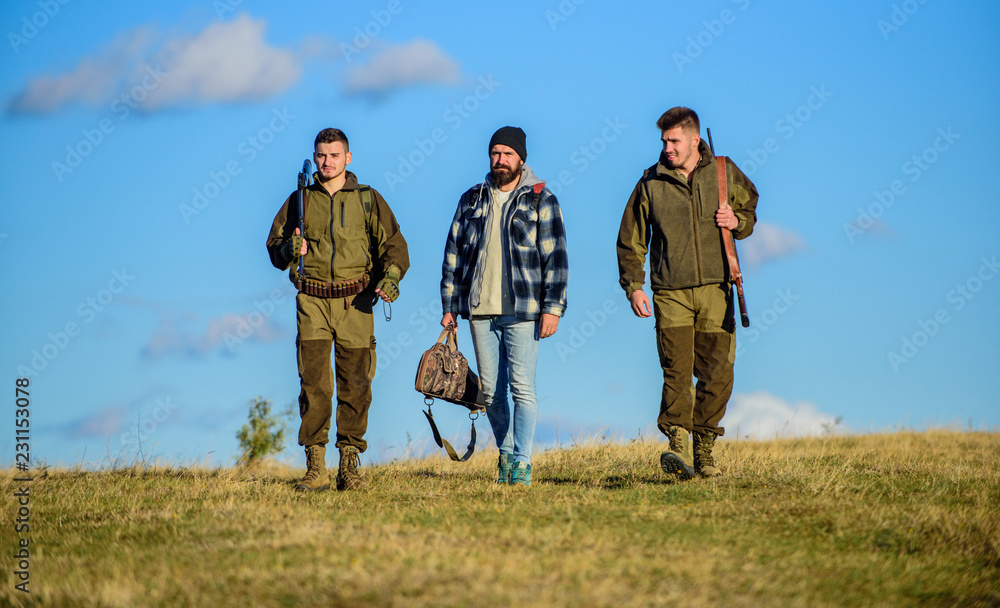 Guys gathered for hunting. Men carry hunting rifles. Hunters with guns ...