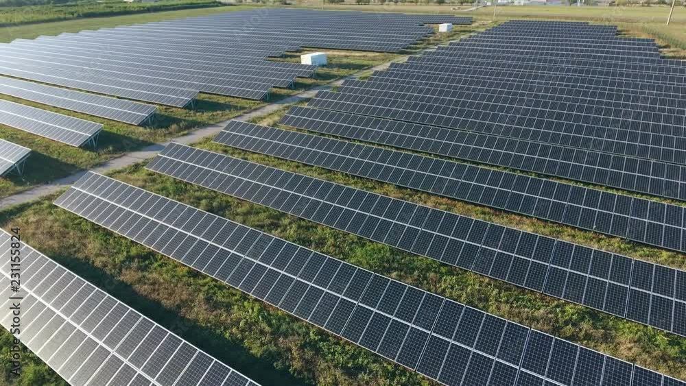 Stunning aerial shot of a shining solar polar station with lines of ...