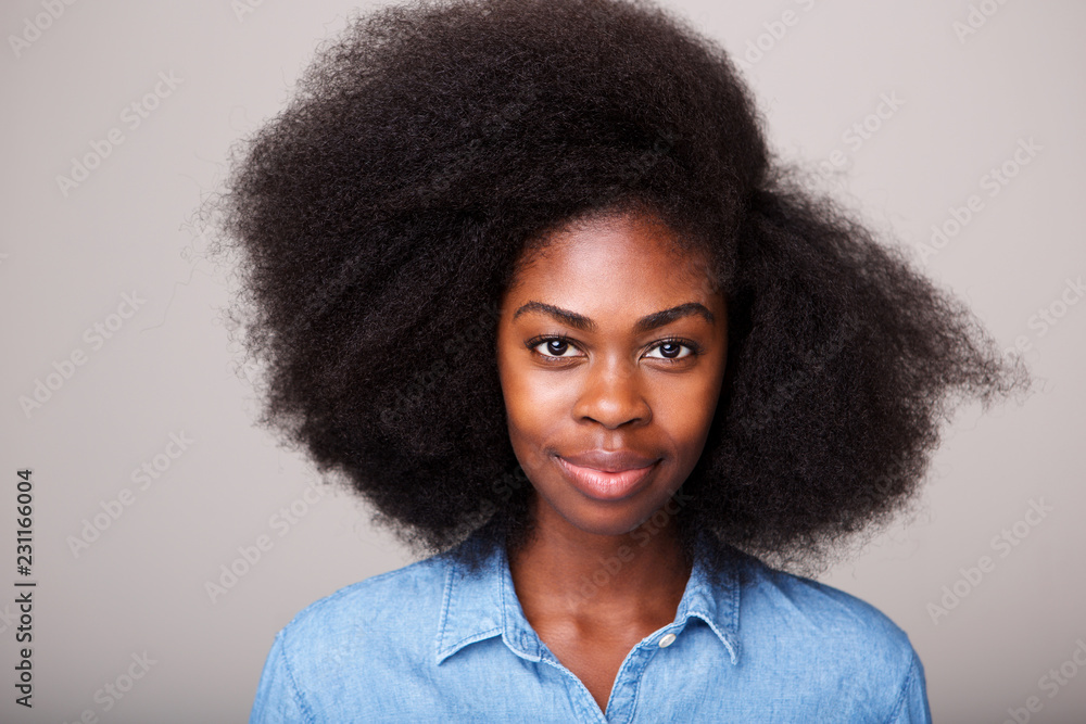 Close up portrait of beautiful young black woman with afro hair staring ...