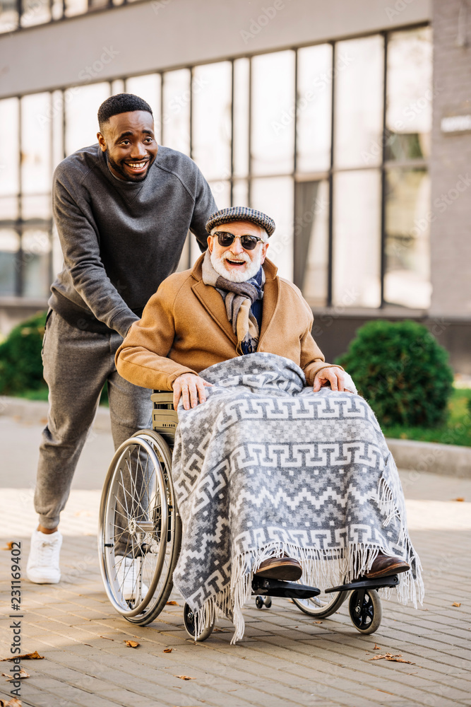 happy senior disabled man in wheelchair with plaid and african american ...