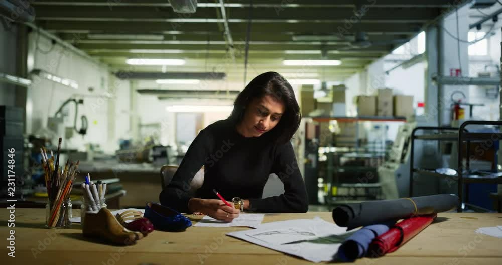 Portrait of professional fashion designer drawing a new shoe model ...