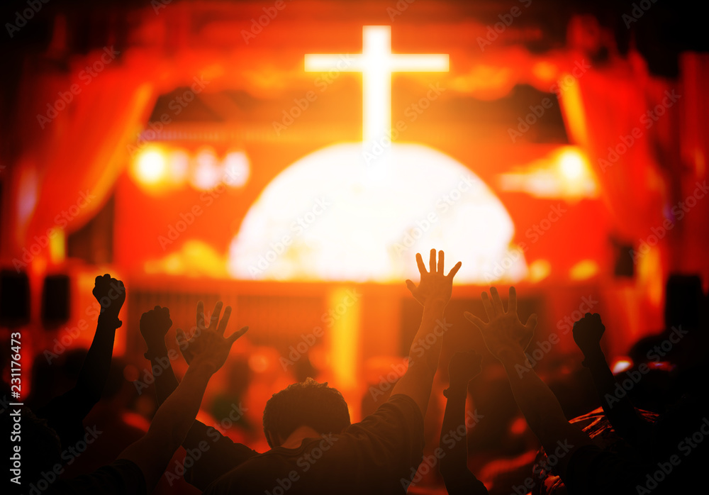 Christians raising their hands in praise and worship at a night music ...