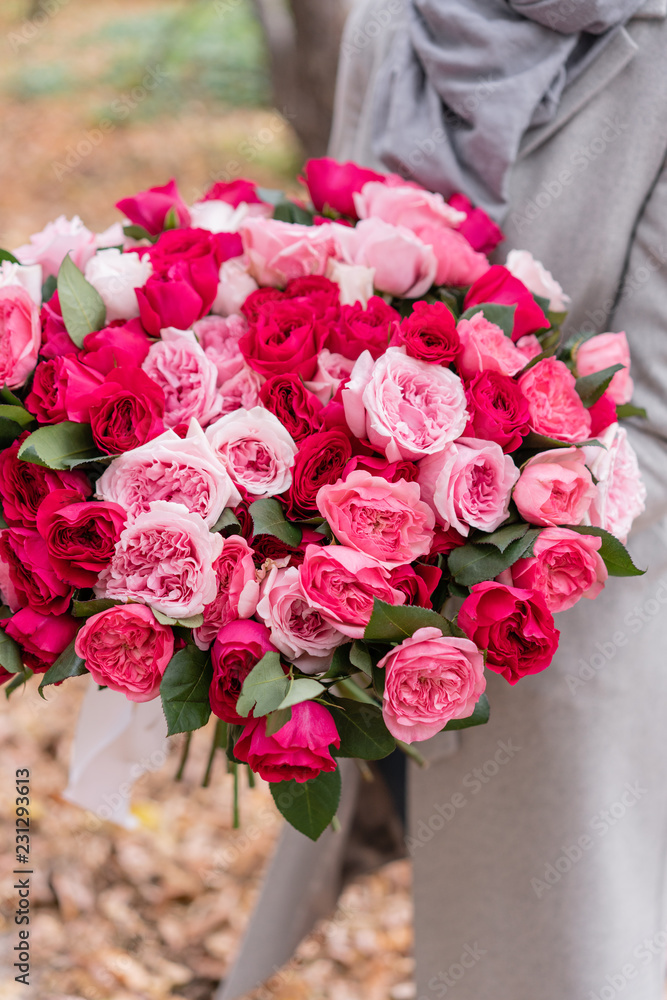 Big luxury bright bouquet in the hands of a cute girl. One hundred ...