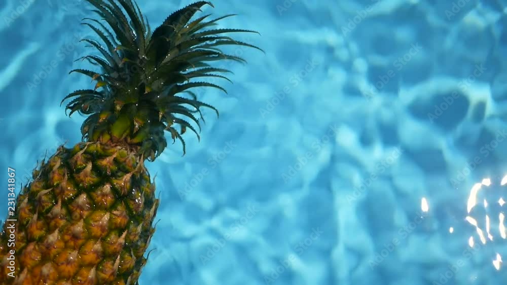 Pineapple Floating In blue Water In Swimming Pool. Healthy Raw Organic ...