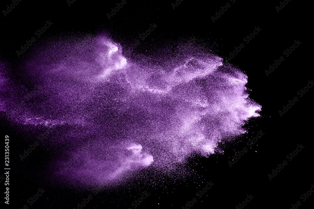 Purple particles explosion on black background. Freeze motion of purple ...