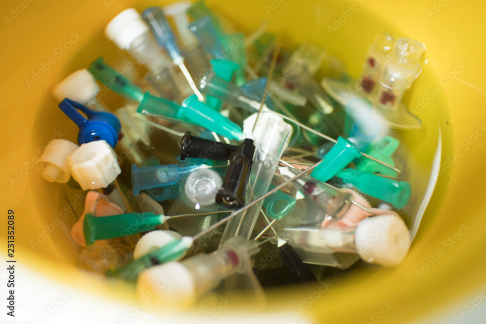 needles and syringes in disinfectant. disposal of medical needles and ...