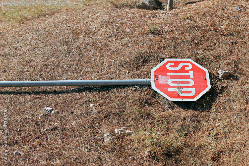 Broken stop traffic sign on the ground concrete base horizontal foto de ...