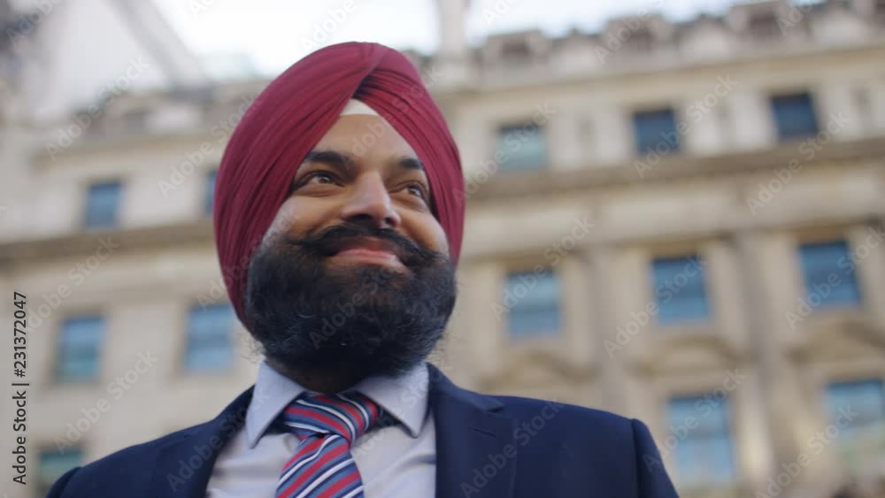 Sikh man in a suit in the city looking around confidently Stock Video ...