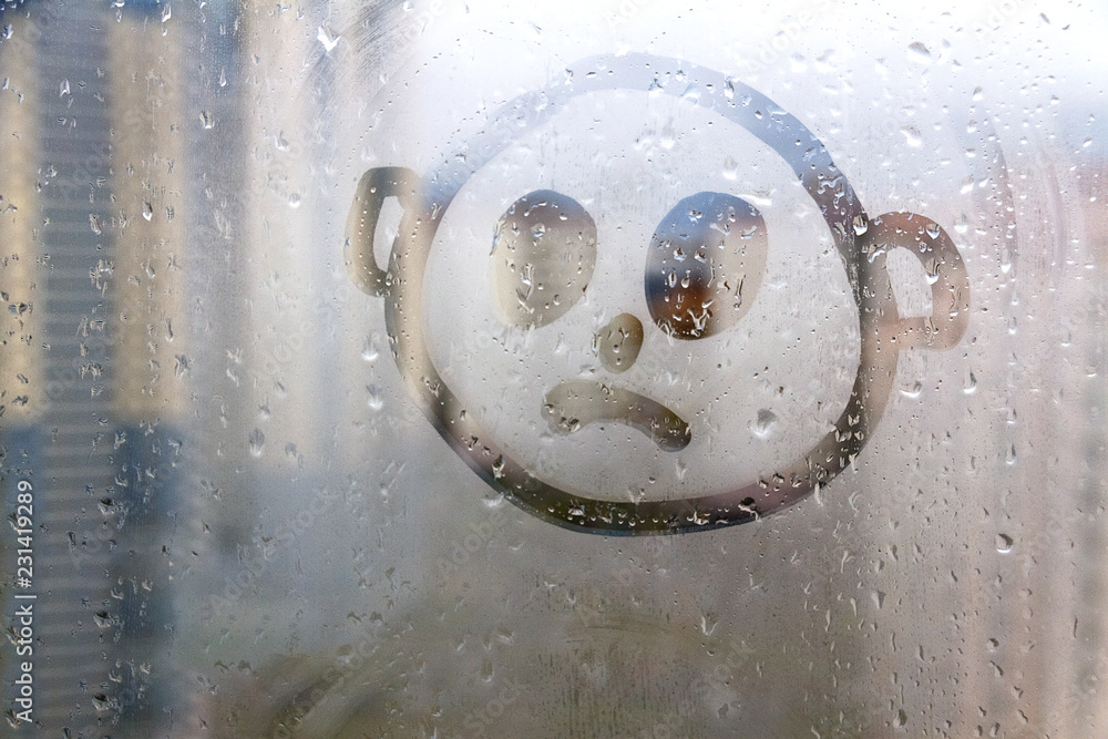 Foggy glass on window with drawn sad face concept photo with copyspace ...