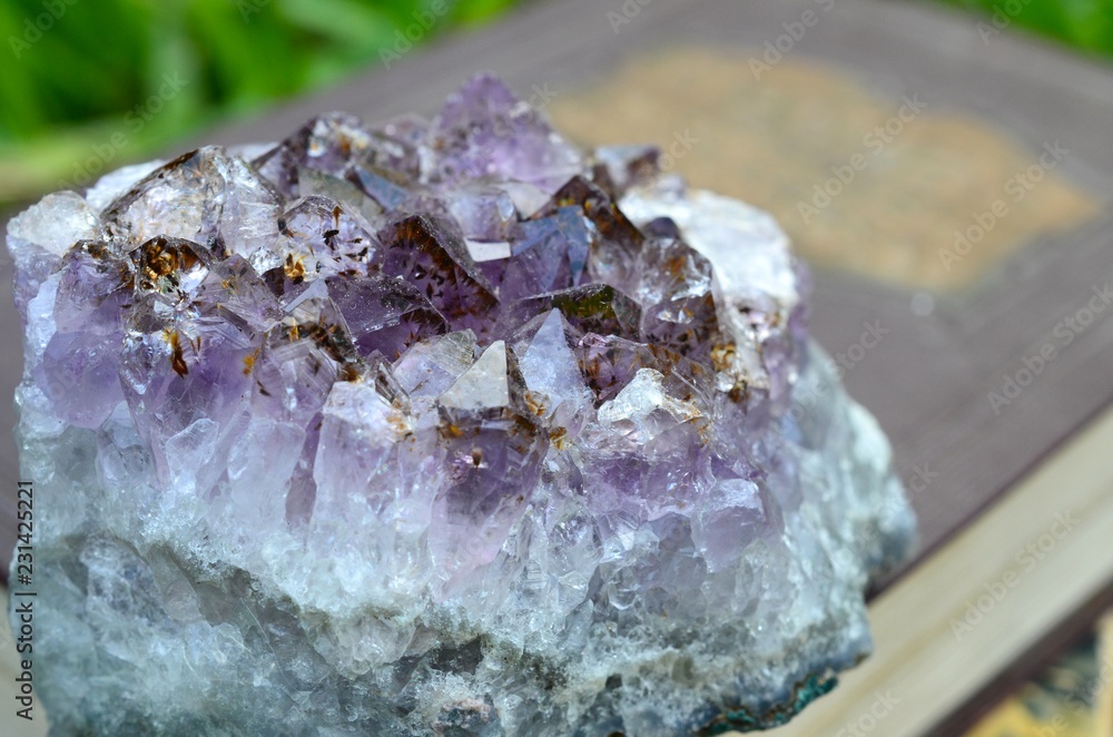 Natural Amethyst out in nature, in the grass. Spring time colors ...