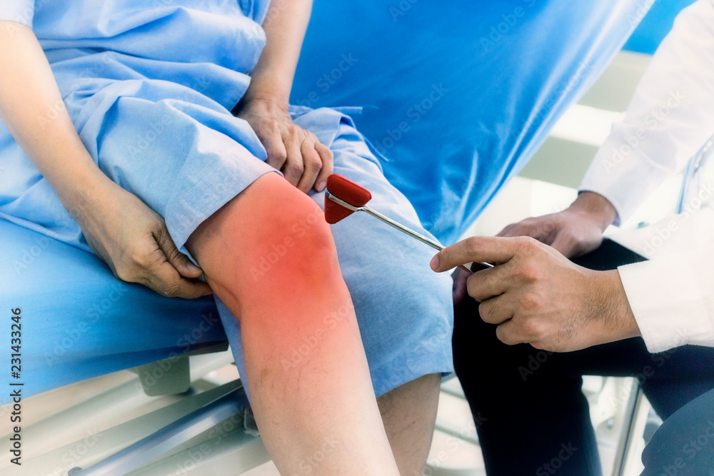 Health care concept; Old patient suffering from knee pain at the ...
