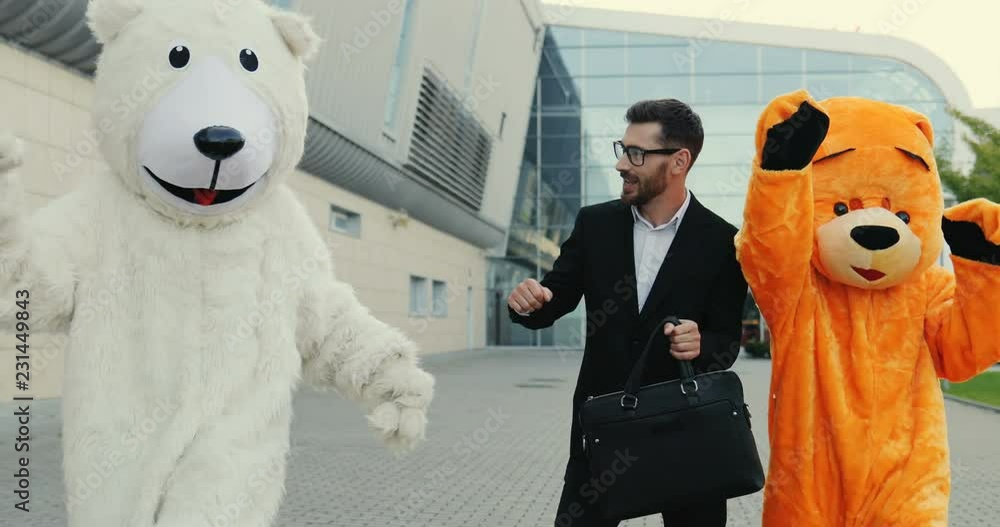 Funny picture of the cheerful Caucasian man in a suit and with a bag in ...