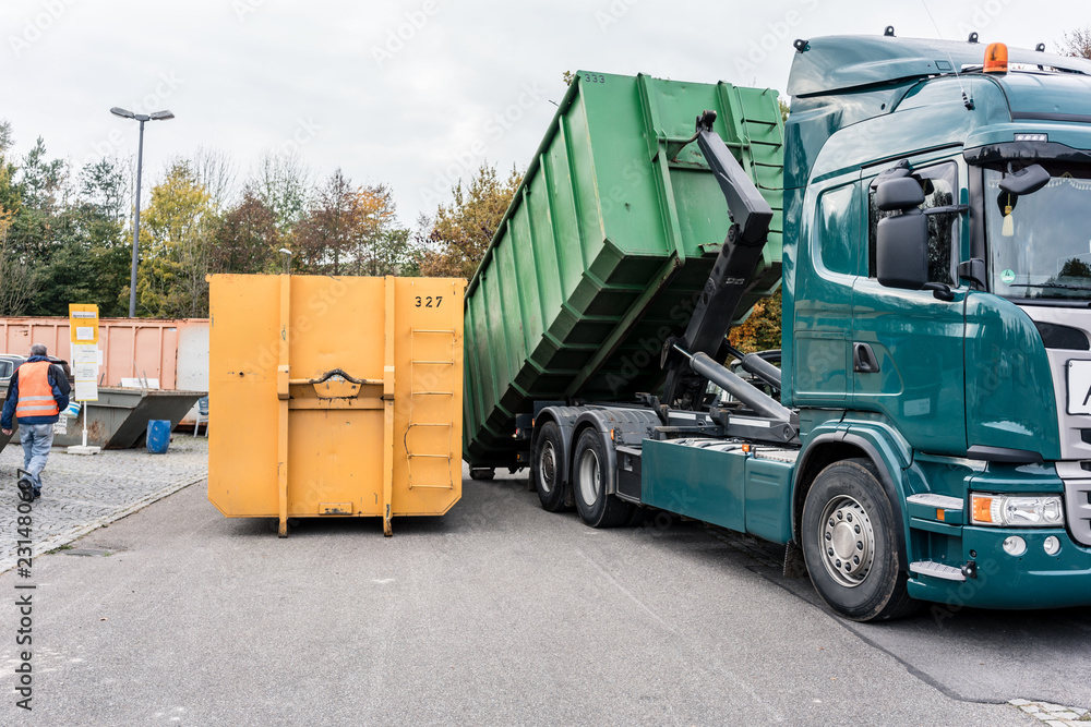 Truck loading container with waste in recycling center to transport ...
