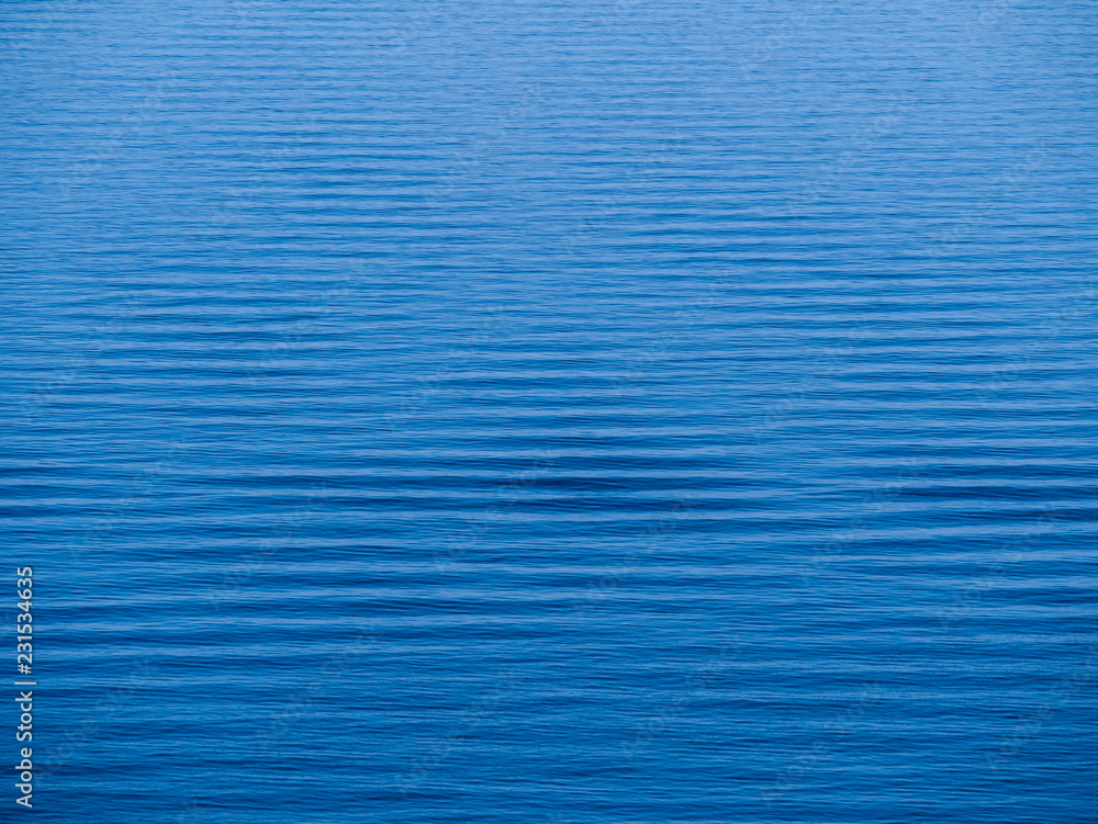 Fine ripples on the water surface. Water background with horizontal ...