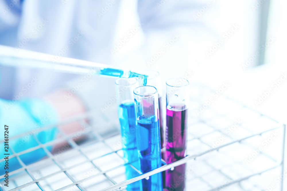 Scientist with equipment holding tools during scientific experiment ...