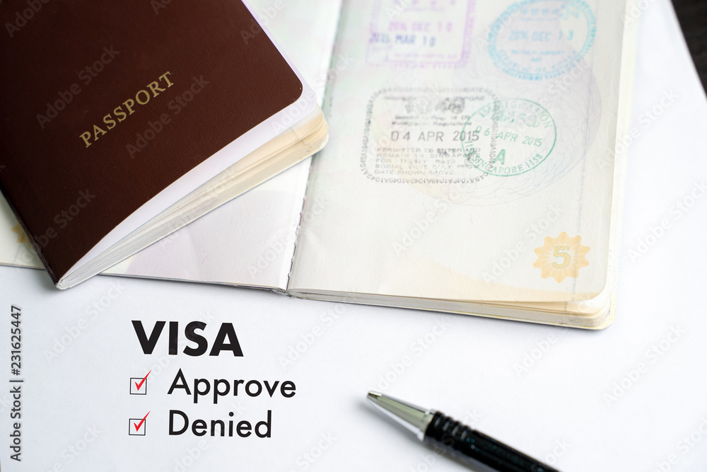 Visa and passport to approved stamped on a document top view in ...