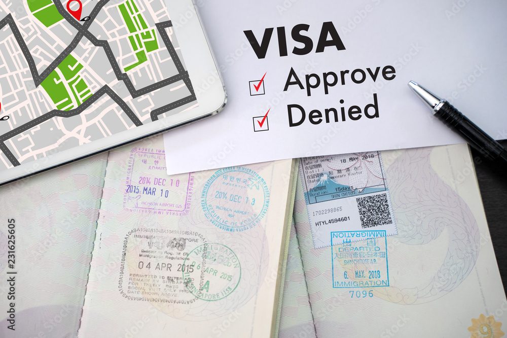 Visa and passport to approved stamped on a document top view in ...