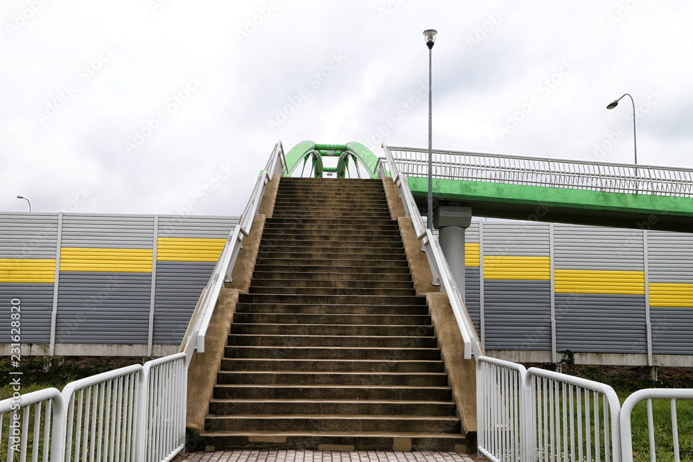 Stairs to elevated pedestrian crossing. Safe passage across the road ...