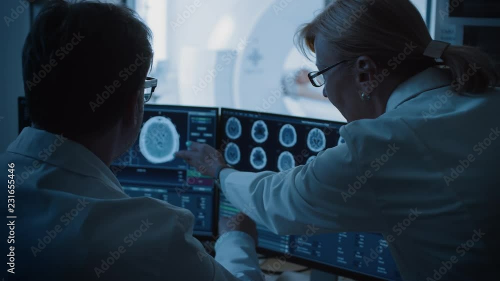 In Control Room Doctor and Radiologist Discuss Diagnosis while Watching ...