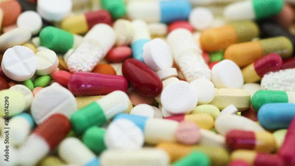 Closeup of many colorful medication pills spinning Stock Video | Adobe ...