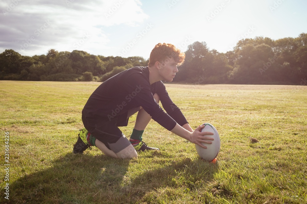 Rugby player placing rugby ball in the field Stock Photo | Adobe Stock