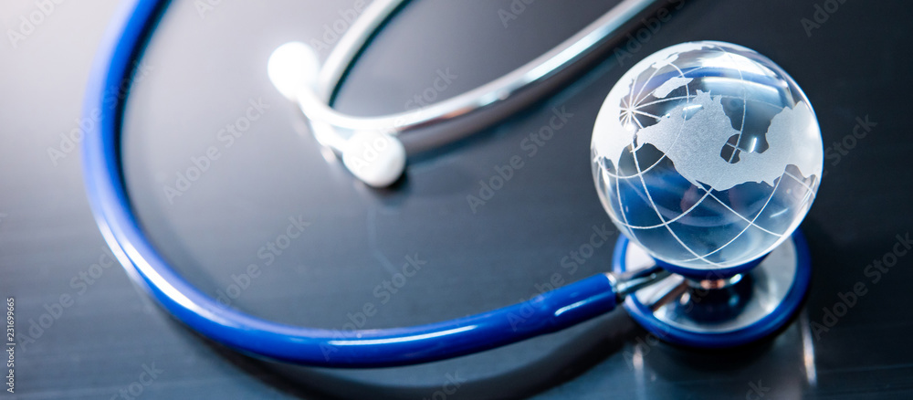 Global healthcare concept. World globe crystal glass on blue ...