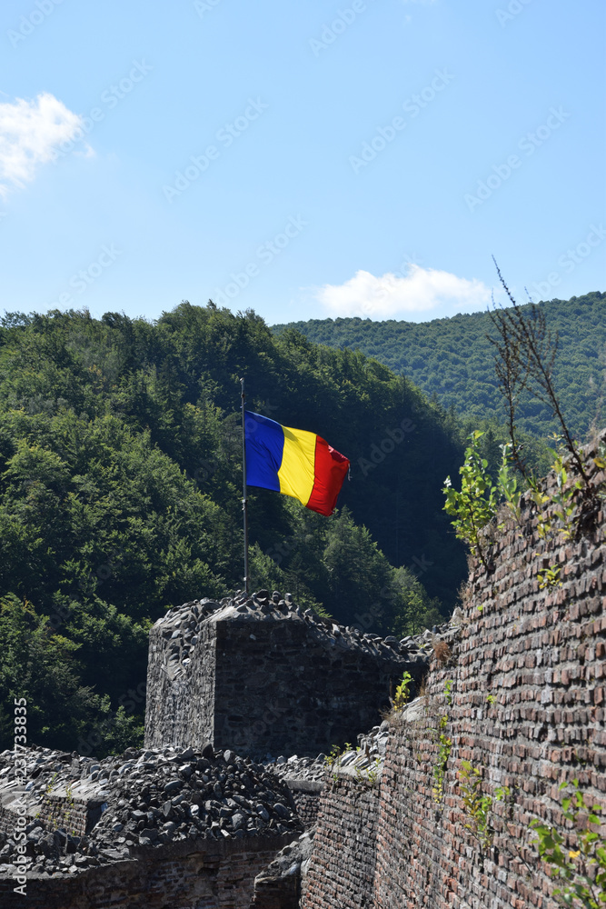 Romanian flag waving in the wind at the ruin of Poenari Castle. Romania ...
