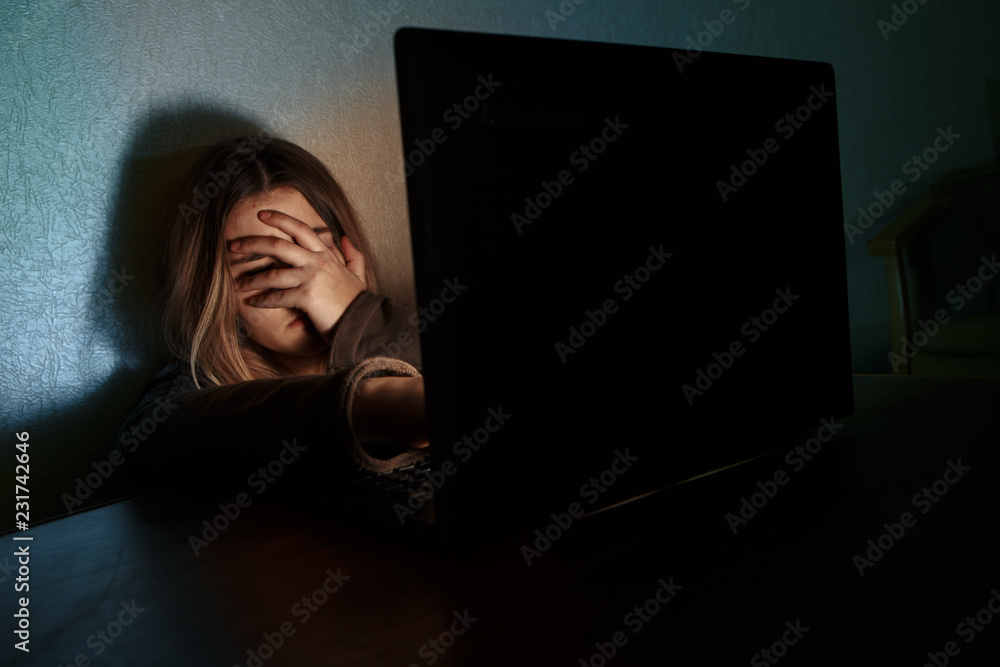 Teenager girl suffering internet cyber bullying scared and depressed ...