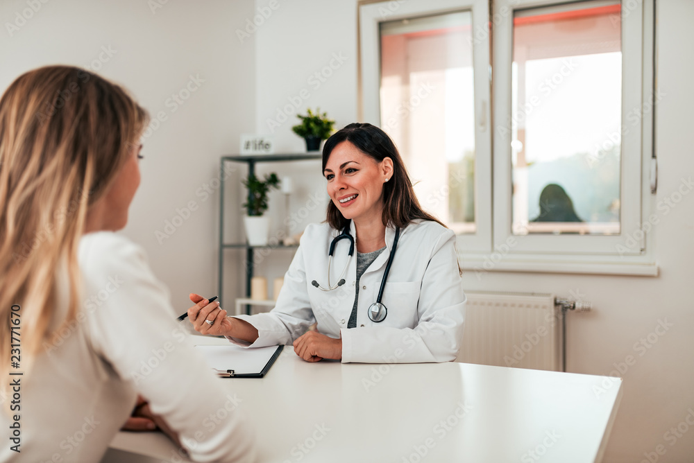 Beautiful female doctor discussing patients treatment with her. Stock ...