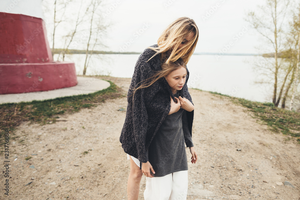 Woman enbrace her daughter at the lighthouse Stock Photo | Adobe Stock