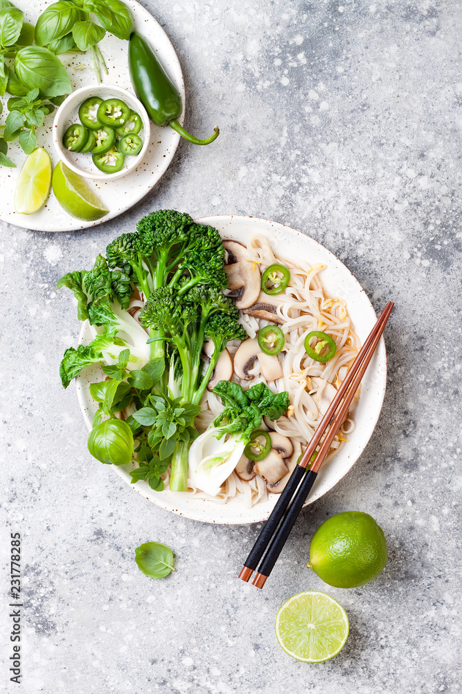 Vegetarian traditional Vietnamese soup Pho bo with herbs, rice noodles ...