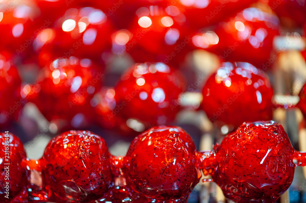 Tanghulu traditional Chinese hard caramel coated fruit skewers close-up ...