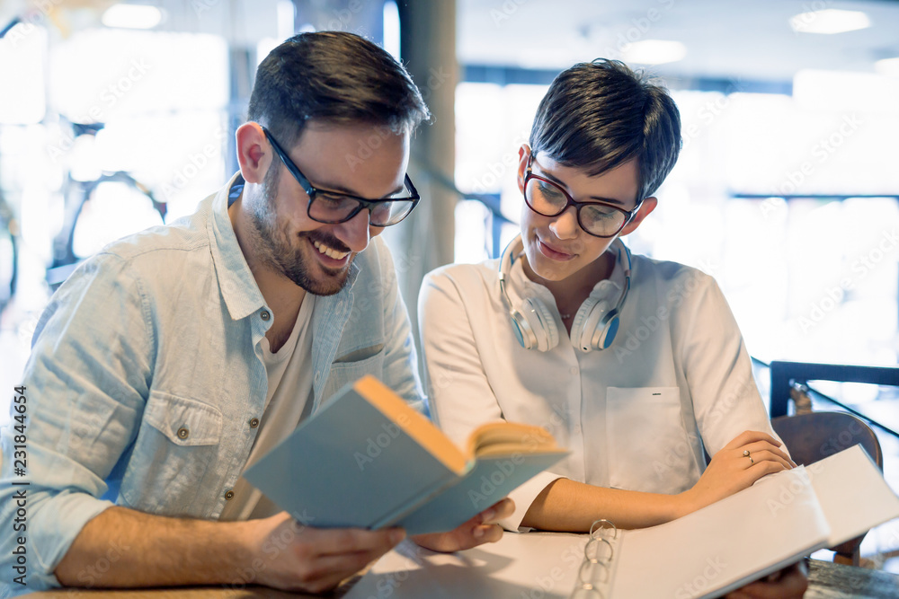 Young beautiful students studying in modern library Stock Photo | Adobe ...