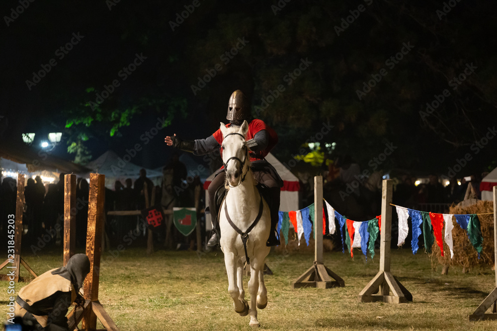 Medieval knight on horse running by night Stock Photo | Adobe Stock