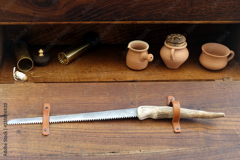 Plakat Various ancient Roman surgical instruments including a saw and a ...