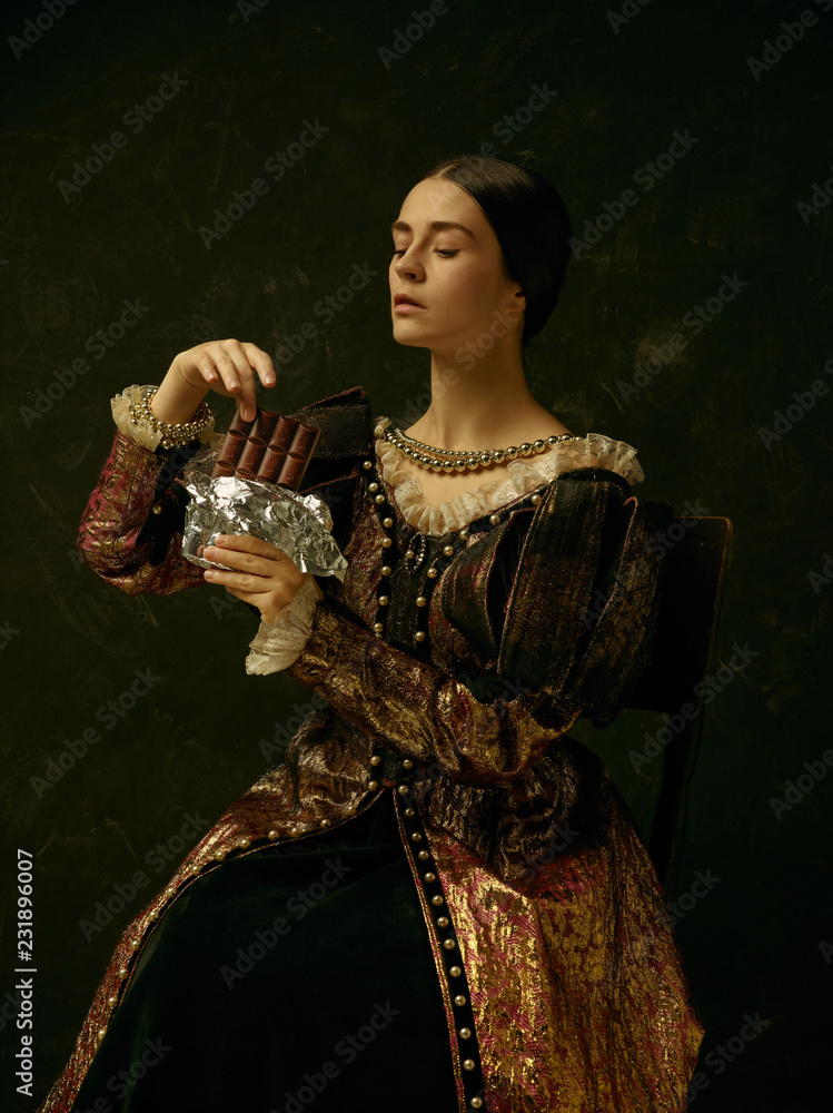 Portrait of a girl wearing a princess or countess dress over dark ...