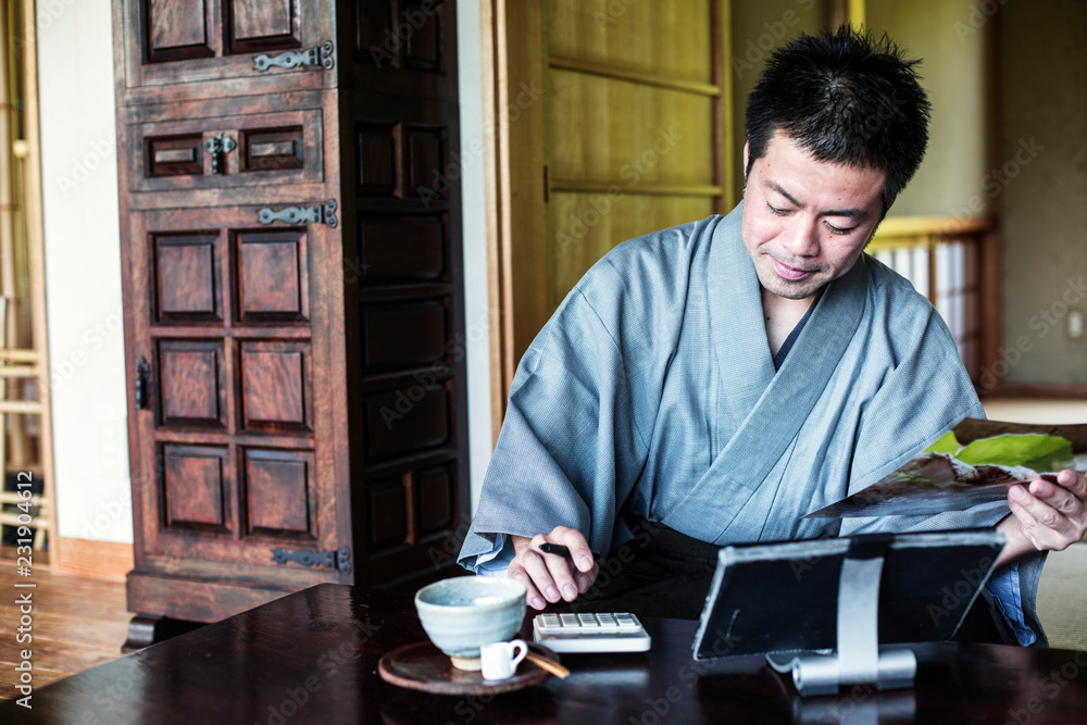 Japanese man wearing kimono sitting on floor in traditional Japanese ...