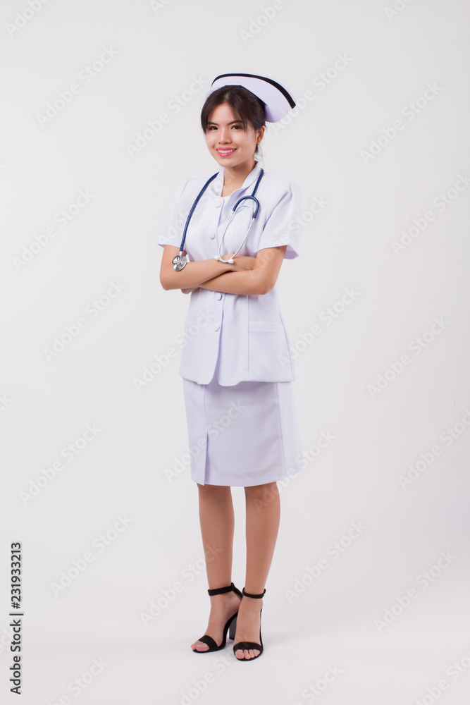 happy, smiling asian woman nurse with stethoscope; studio isolated ...
