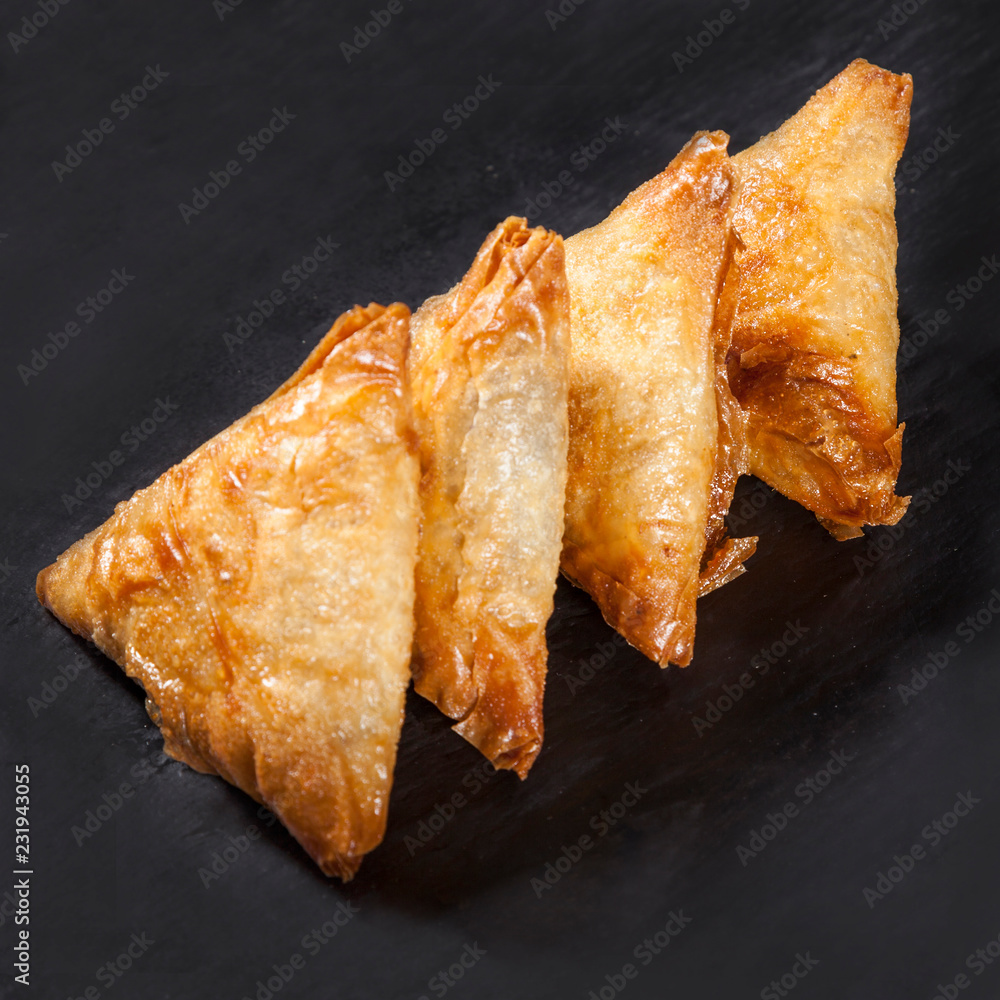 Indian samosas on black background Stock Photo | Adobe Stock