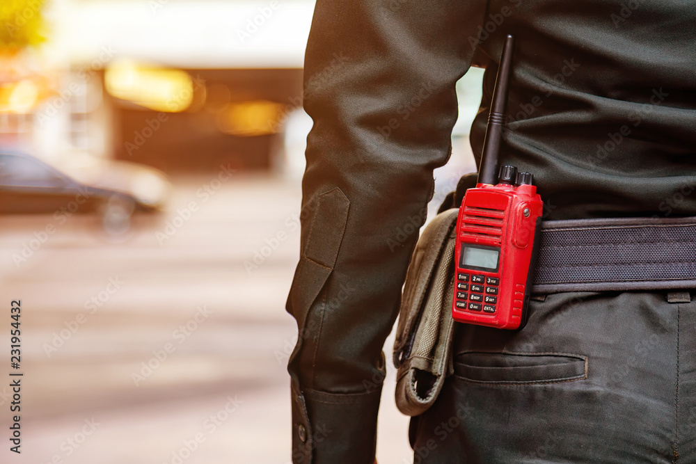 Security guard uses radio communication for facilitate traffic. Traffic ...