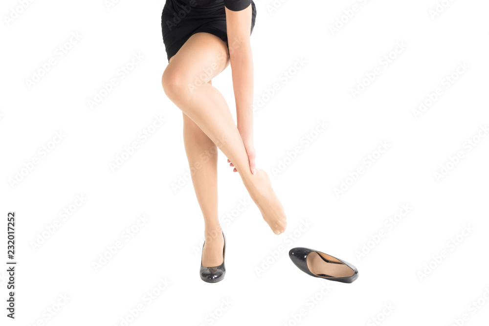 woman take off her highheel tight shoe and mass her weary bare foot ...